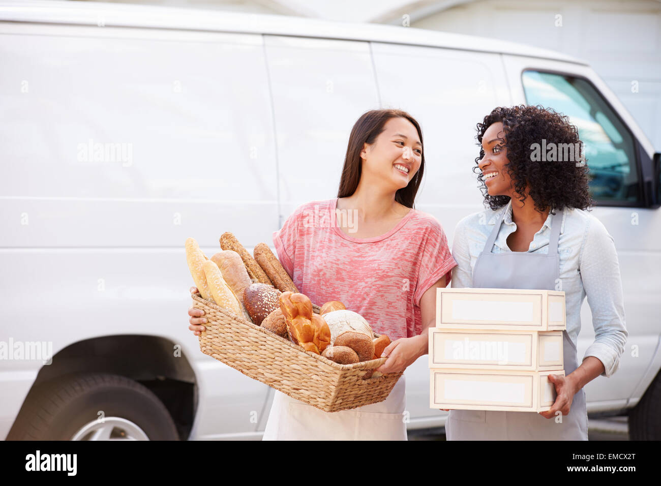 Female Bakers With Bread And Cakes Standing In Front Of Van Stock Photo ...