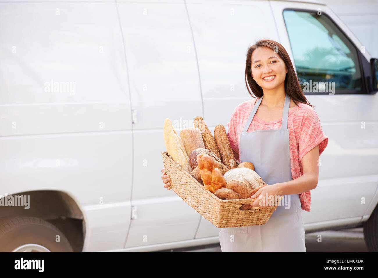 Female Baker Delivering Bread Standing In Front Of Van Stock Photo - Alamy