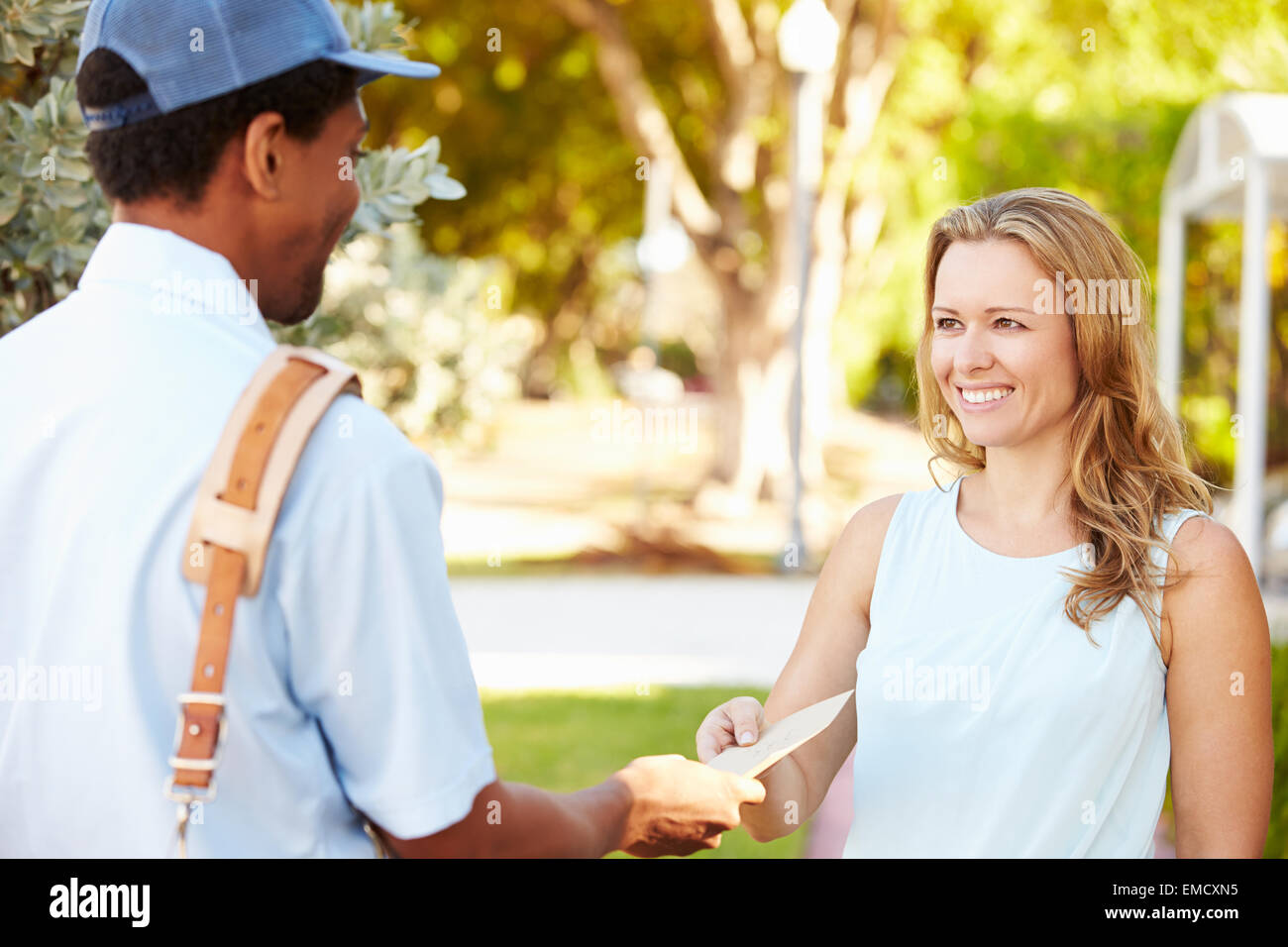 Mailman Delivering Letters To Woman Stock Photo - Alamy