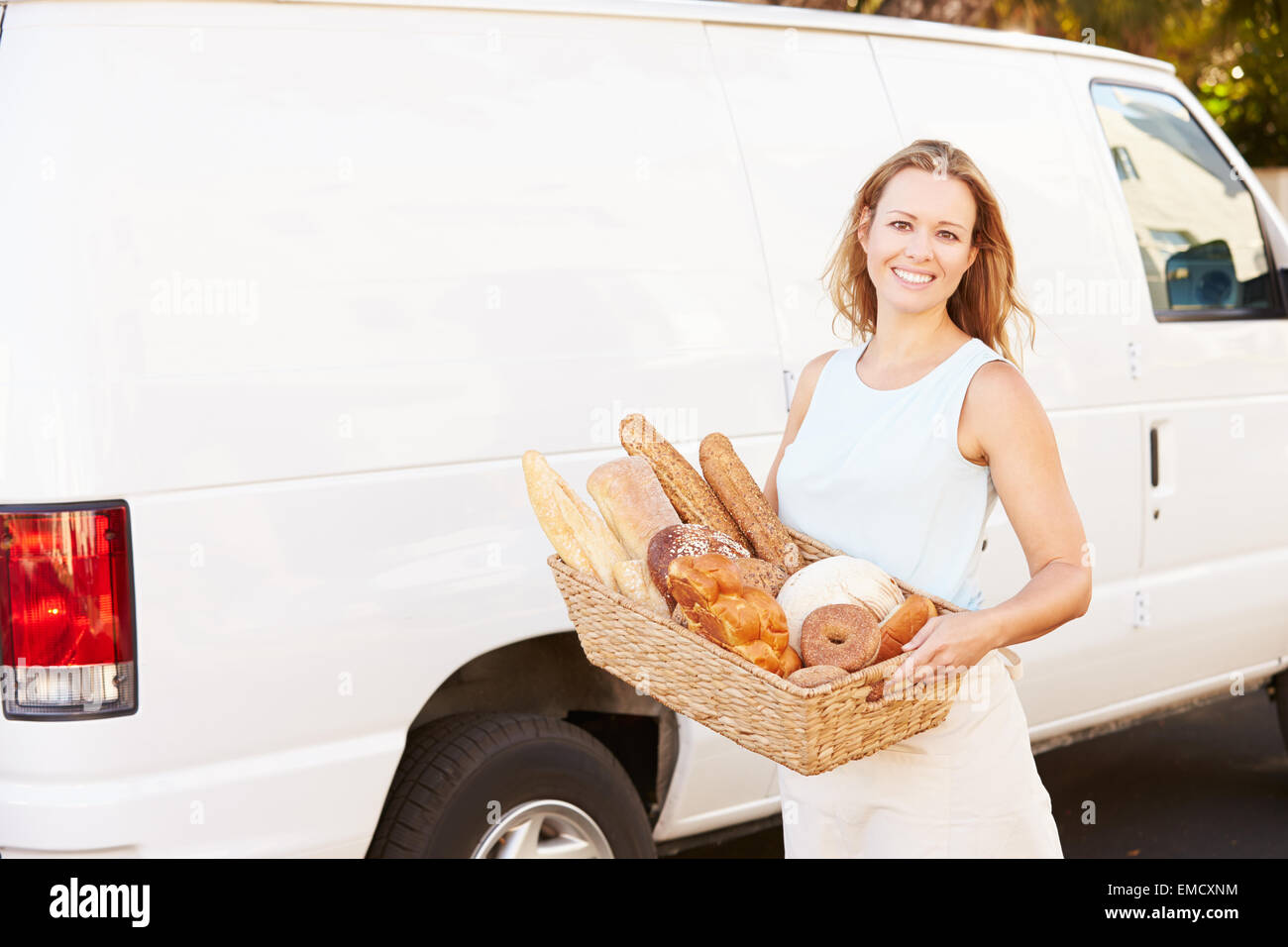 Female Baker Delivering Bread Standing In Front Of Van Stock Photo - Alamy