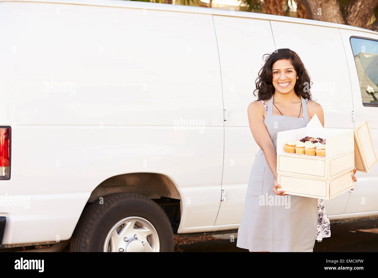 Female Baker Delivering Cakes Standing In Front Of Van Stock Photo - Alamy