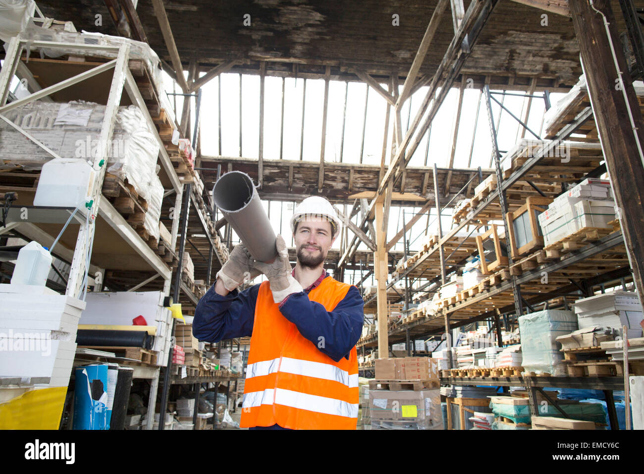 Worker carrying pipe hi-res stock photography and images - Alamy