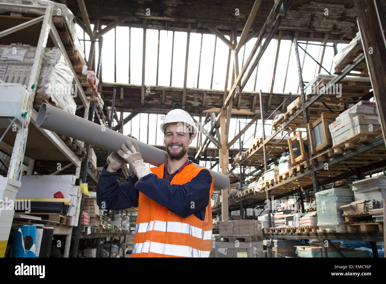 Worker carrying pipe hi-res stock photography and images - Alamy