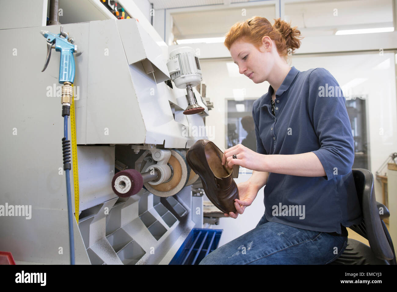 Female shoemaker polishing shoe Stock Photo - Alamy