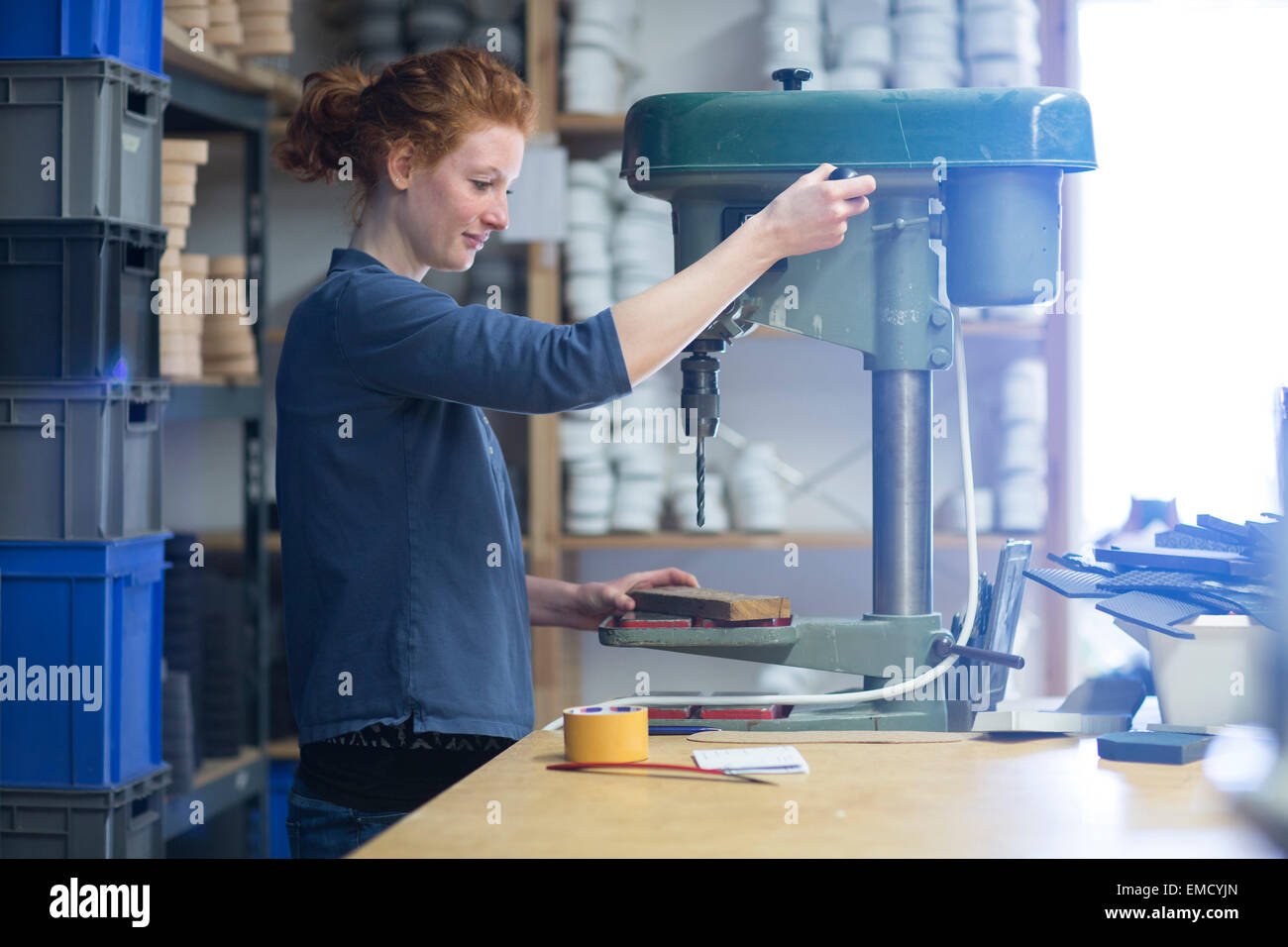 Young woman drilling in workshop Stock Photo - Alamy