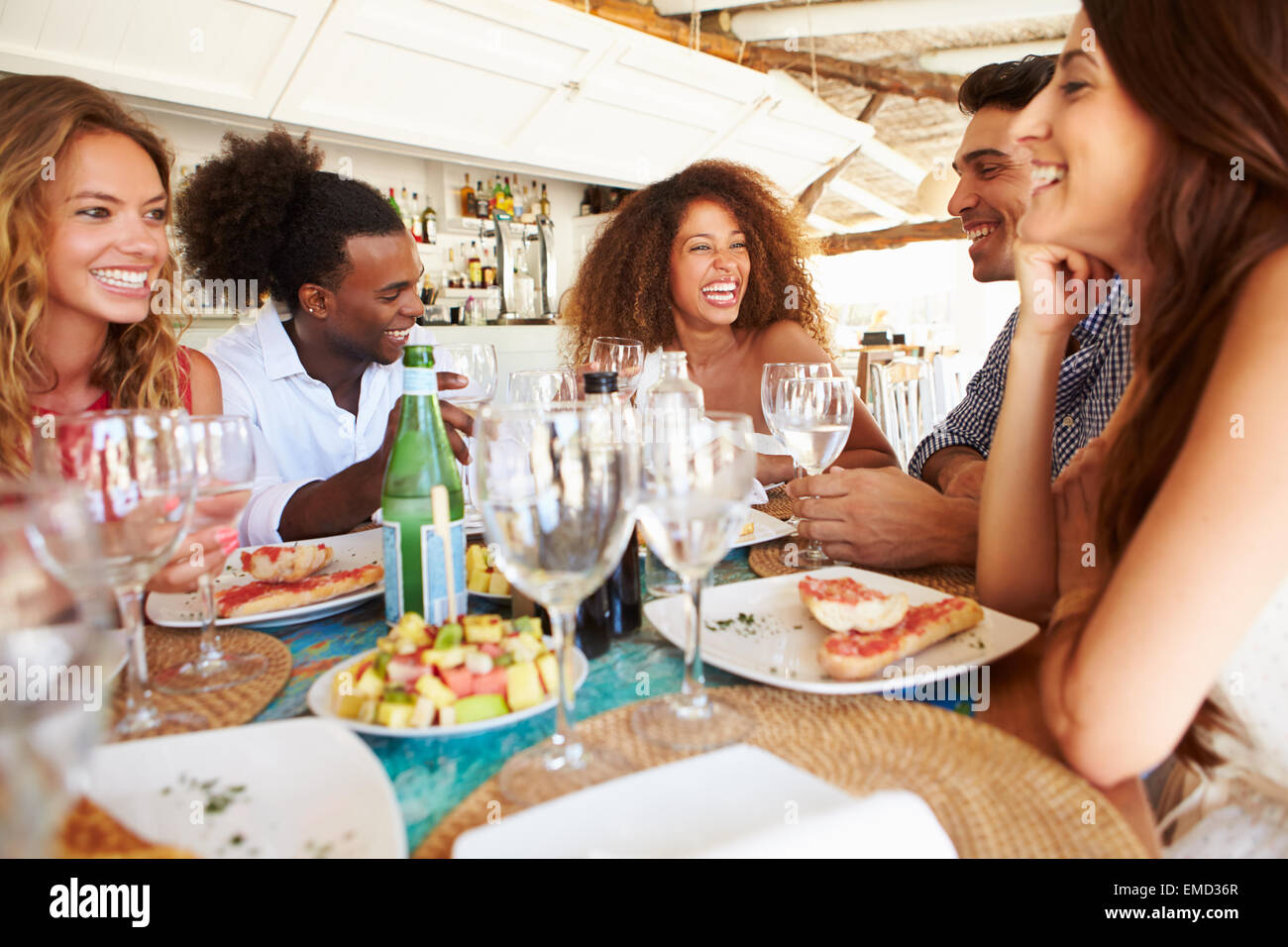 Group Of Young Friends Enjoying Meal In Outdoor Restaurant Stock Photo ...