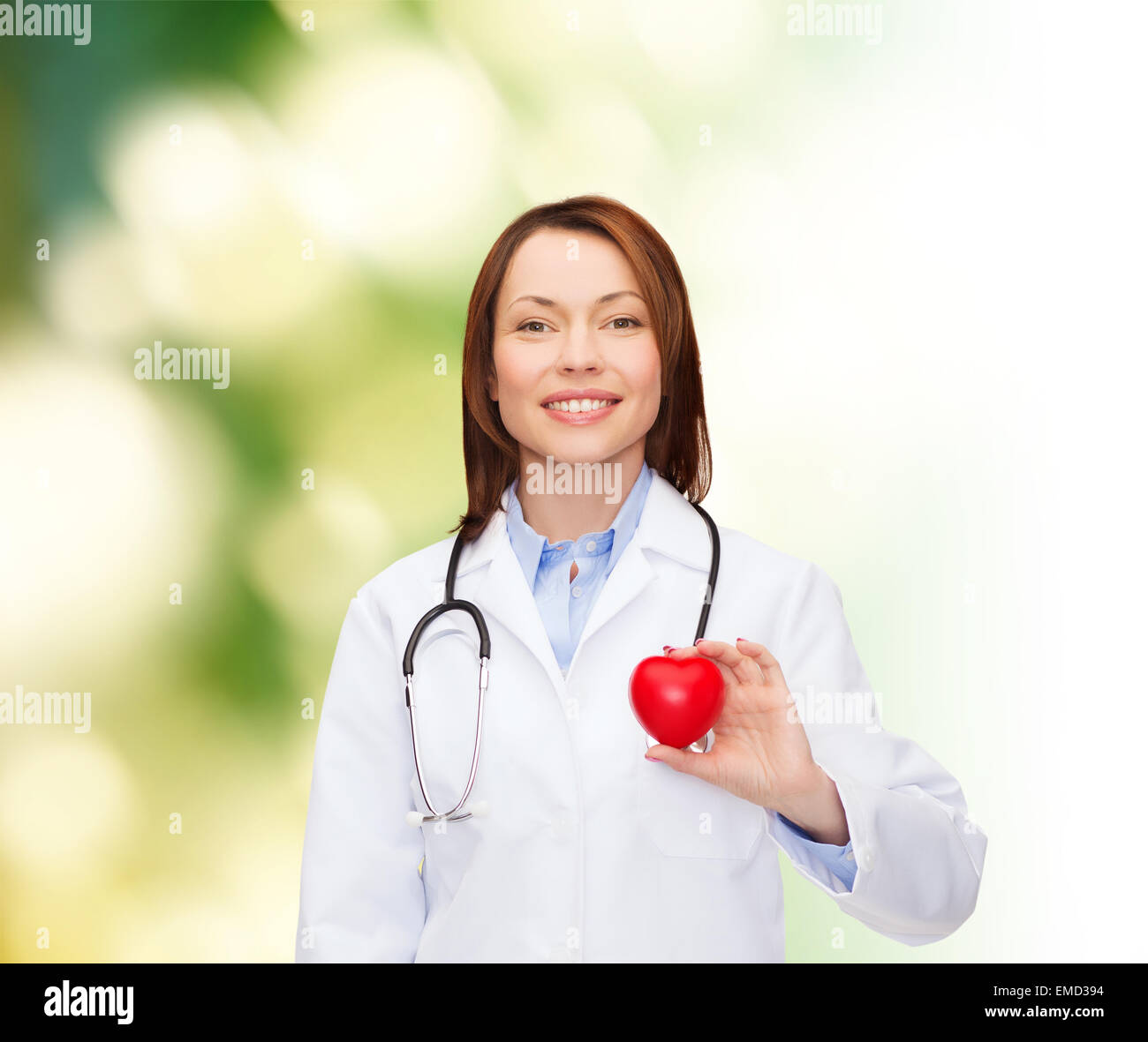 smiling female doctor with heart and stethoscope Stock Photo - Alamy