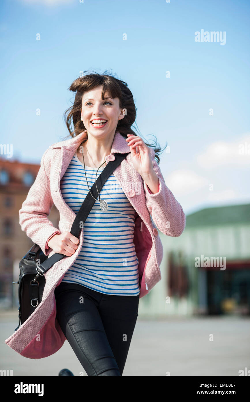 Young woman running in the street Stock Photo - Alamy
