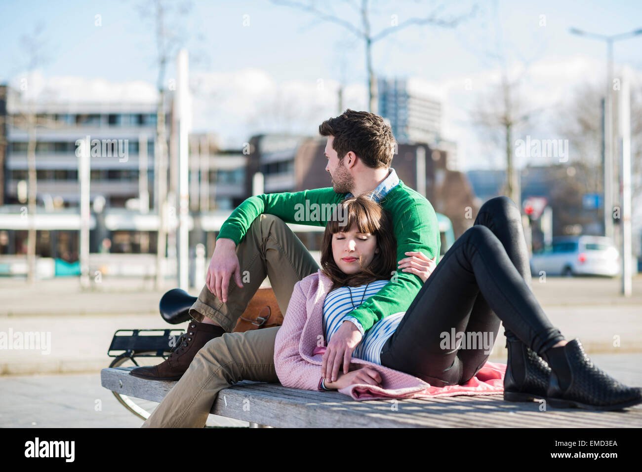 Happy couple resting on bench Stock Photo - Alamy