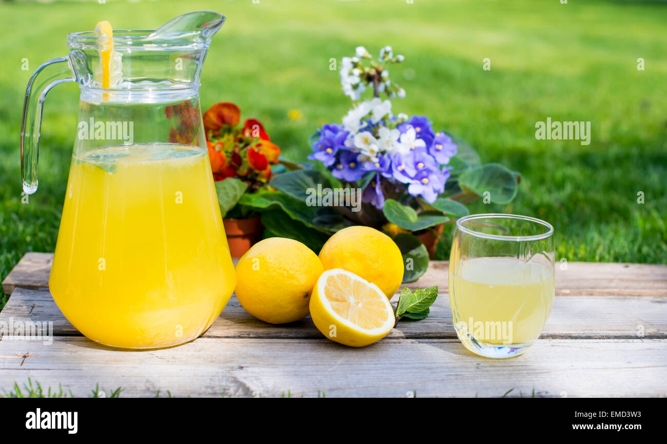 Lemonade in the jug and lemons on the table outdoor Stock Photo - Alamy