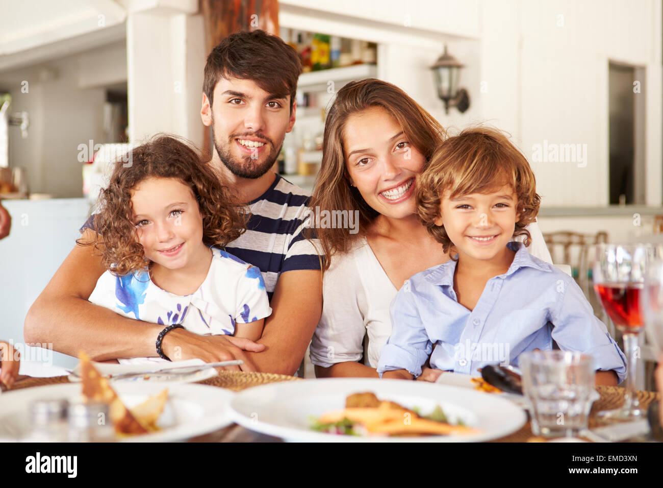 Portrait Of Family Enjoying Meal In Restaurant Stock Photo - Alamy