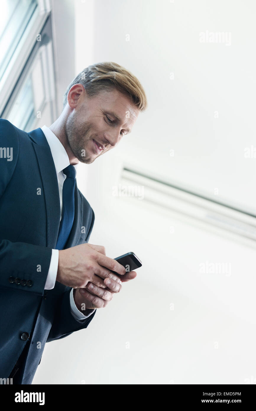 Businessman using mobile phone Stock Photo - Alamy