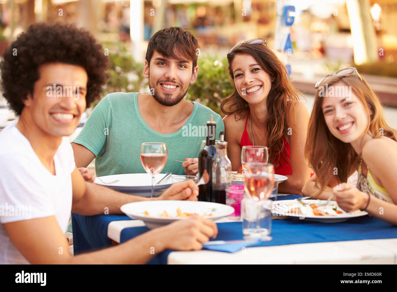 Group Of Young Friends Enjoying Meal In Outdoor Restaurant Stock Photo ...