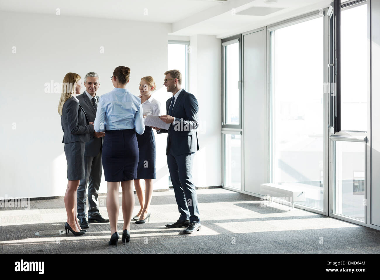 Business people standing in circle, talking Stock Photo - Alamy