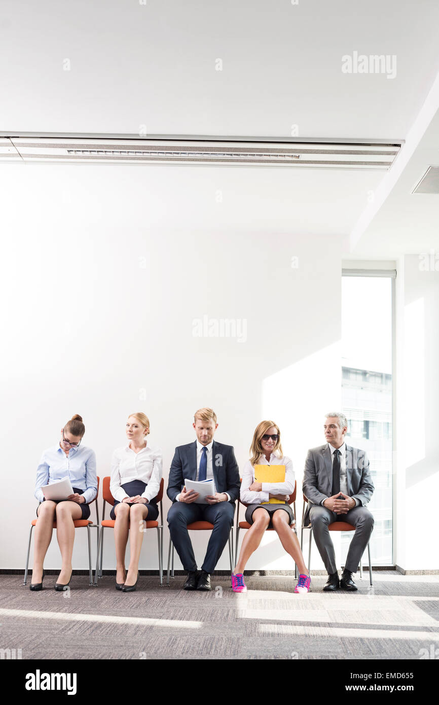 People sitting in a row, waiting for job interview Stock Photo - Alamy