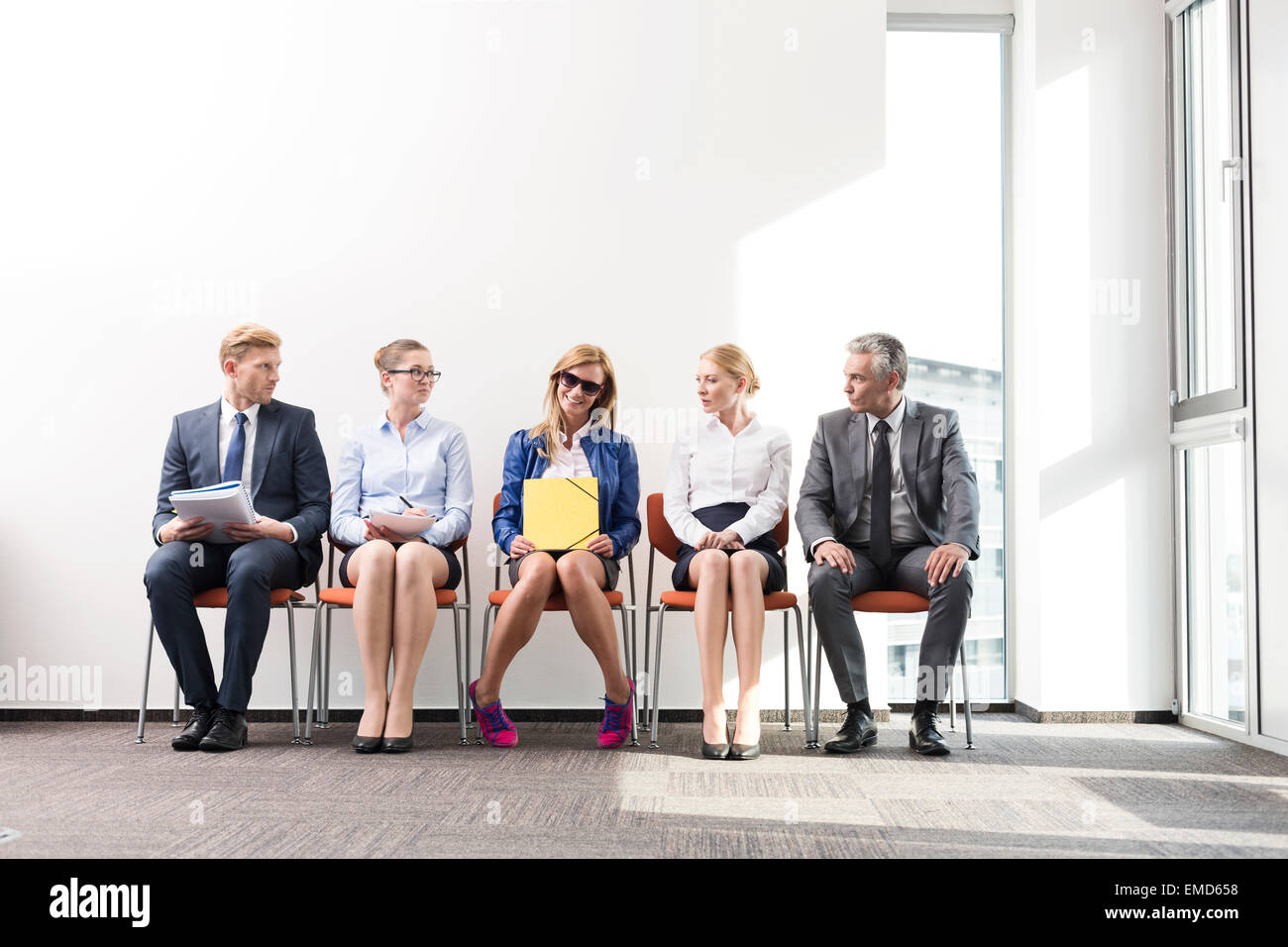People sitting in a row, waiting for job interview Stock Photo - Alamy