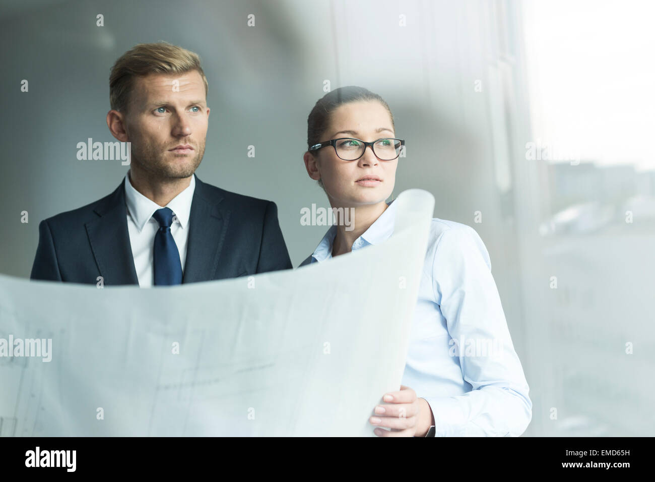 Business people holing construction plan Stock Photo - Alamy