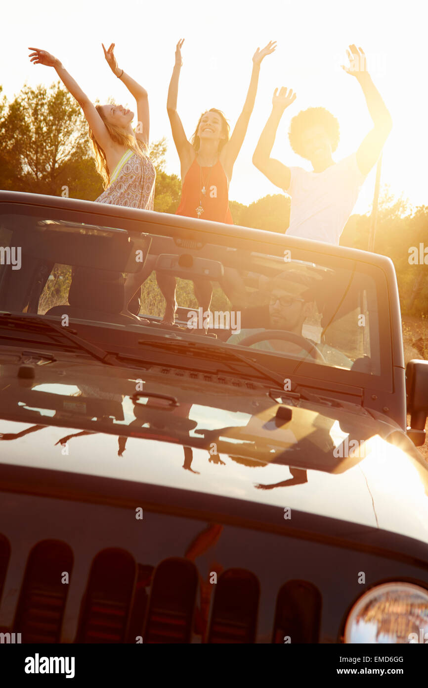 Three Women Dancing In Back Of Open Top Car Stock Photo - Alamy