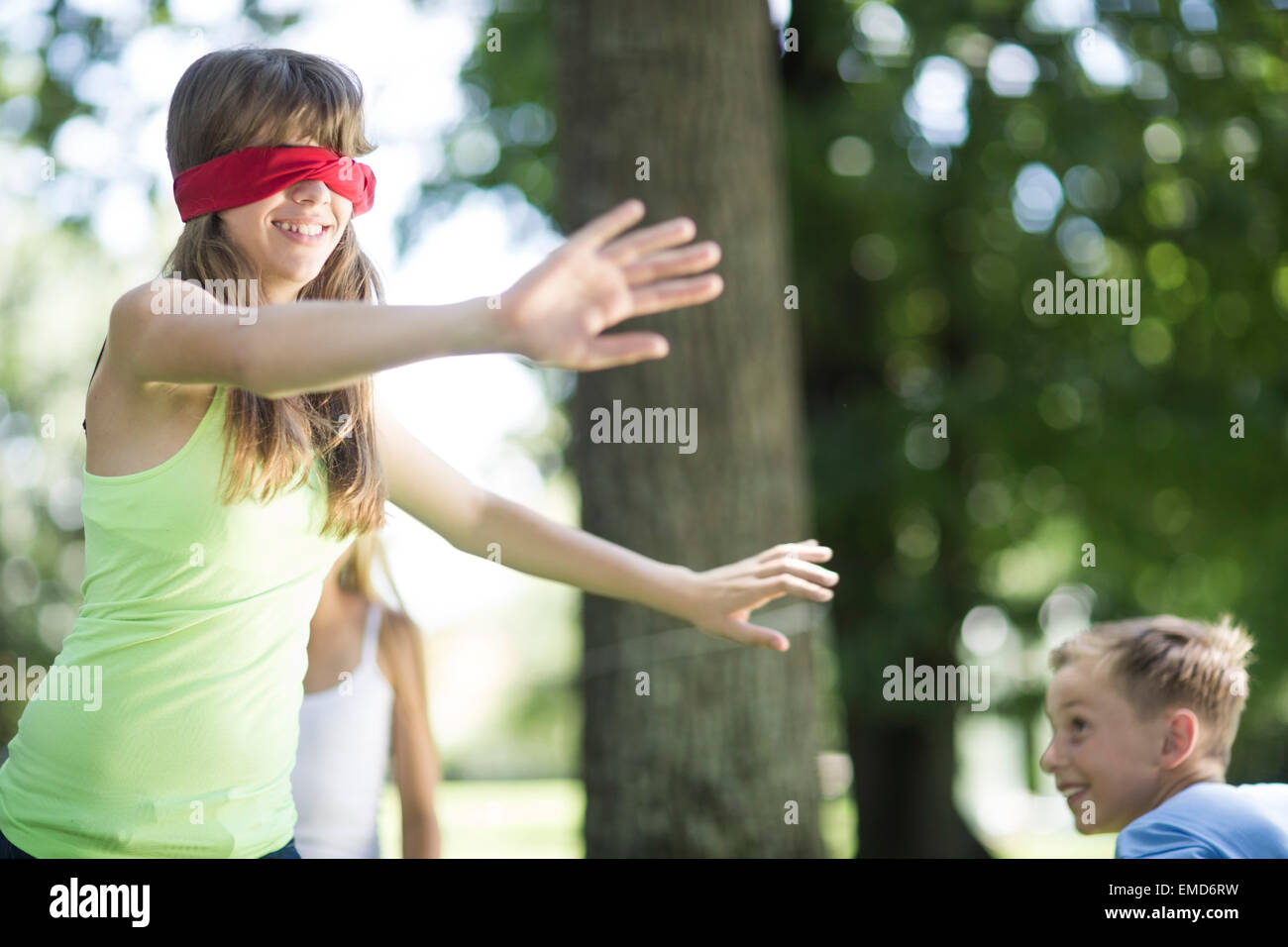 Kids in garden playing blind man's buff Stock Photo - Alamy