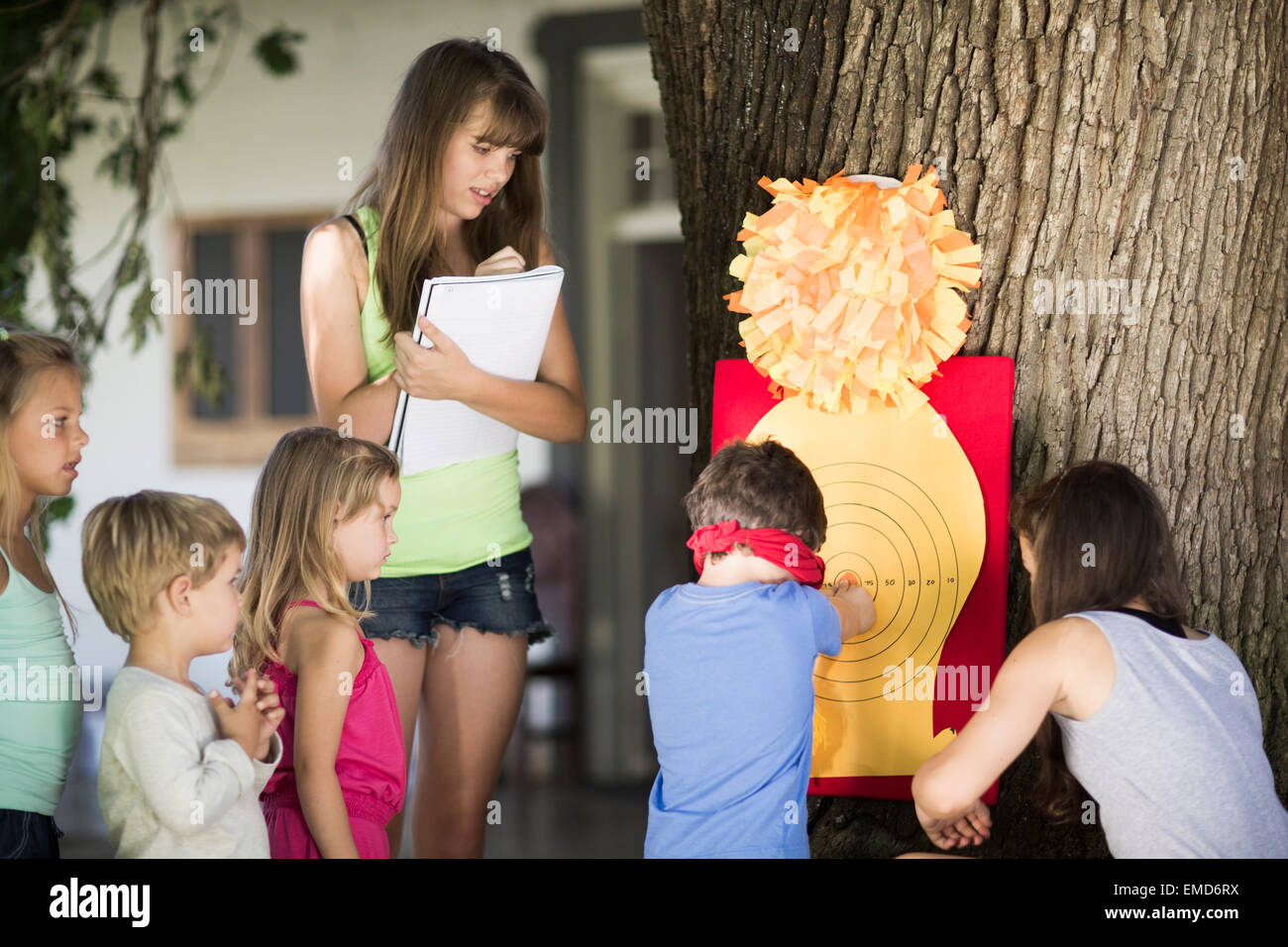 Kids in garden playing pin the tail on the donkey Stock Photo - Alamy