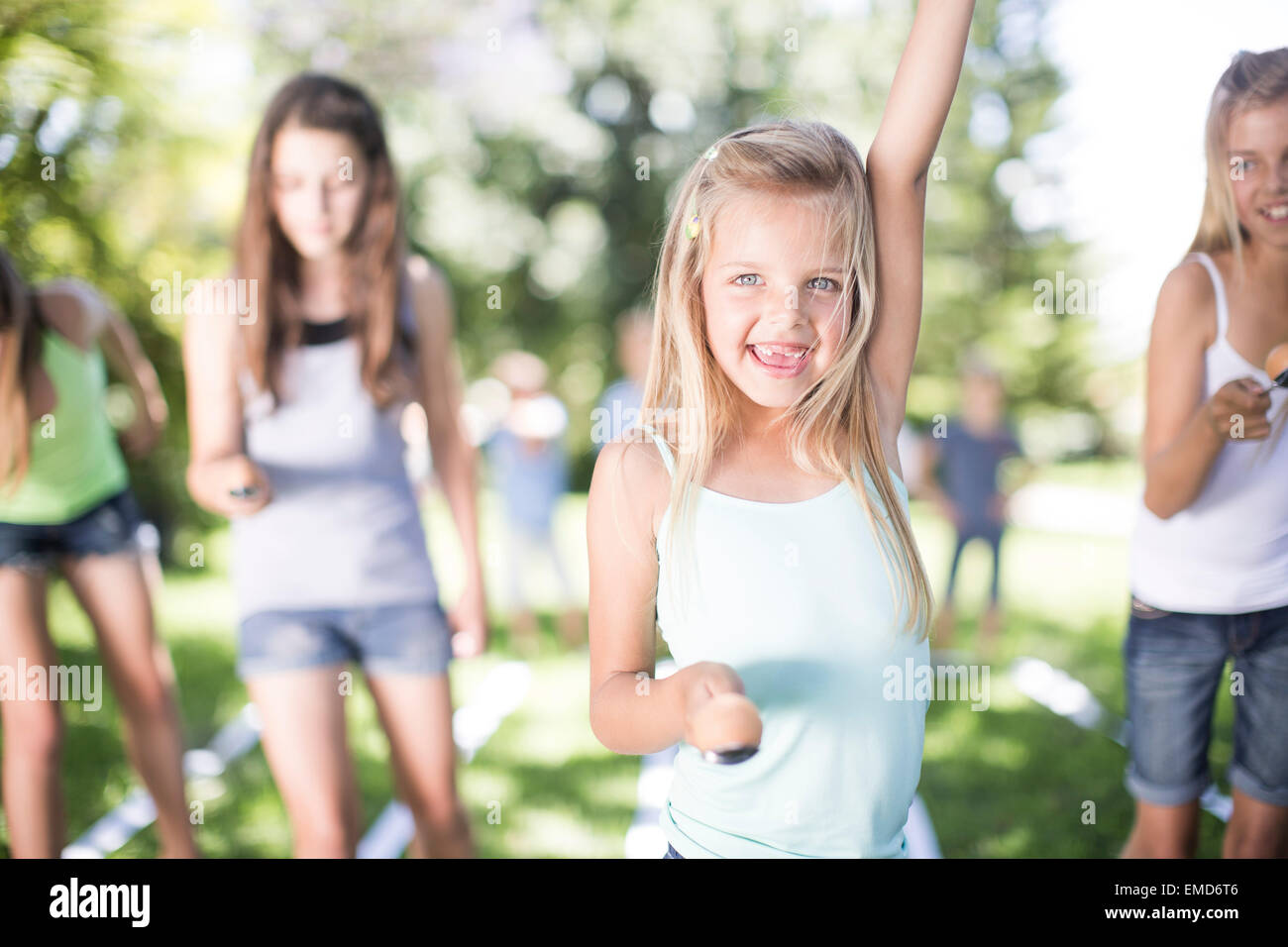 Girl winning in an egg-and-spoon race Stock Photo - Alamy