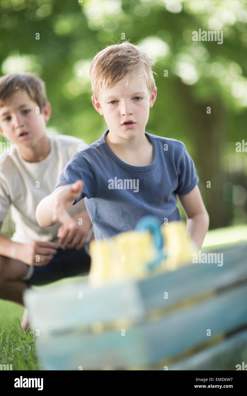 Boys in garden playing quoits Stock Photo - Alamy