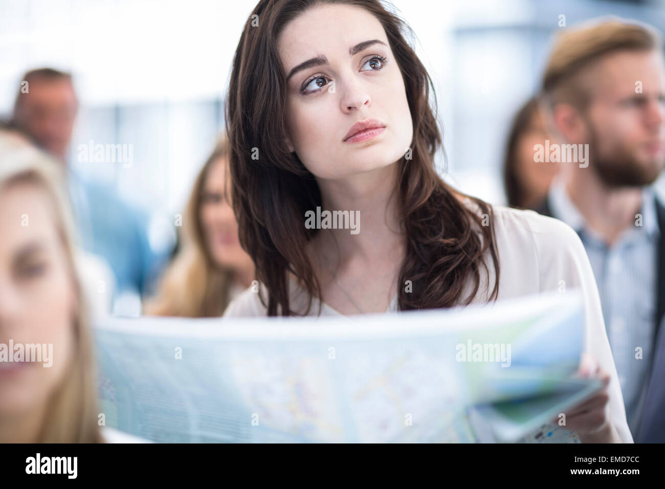 Woman with map in busy city Stock Photo - Alamy