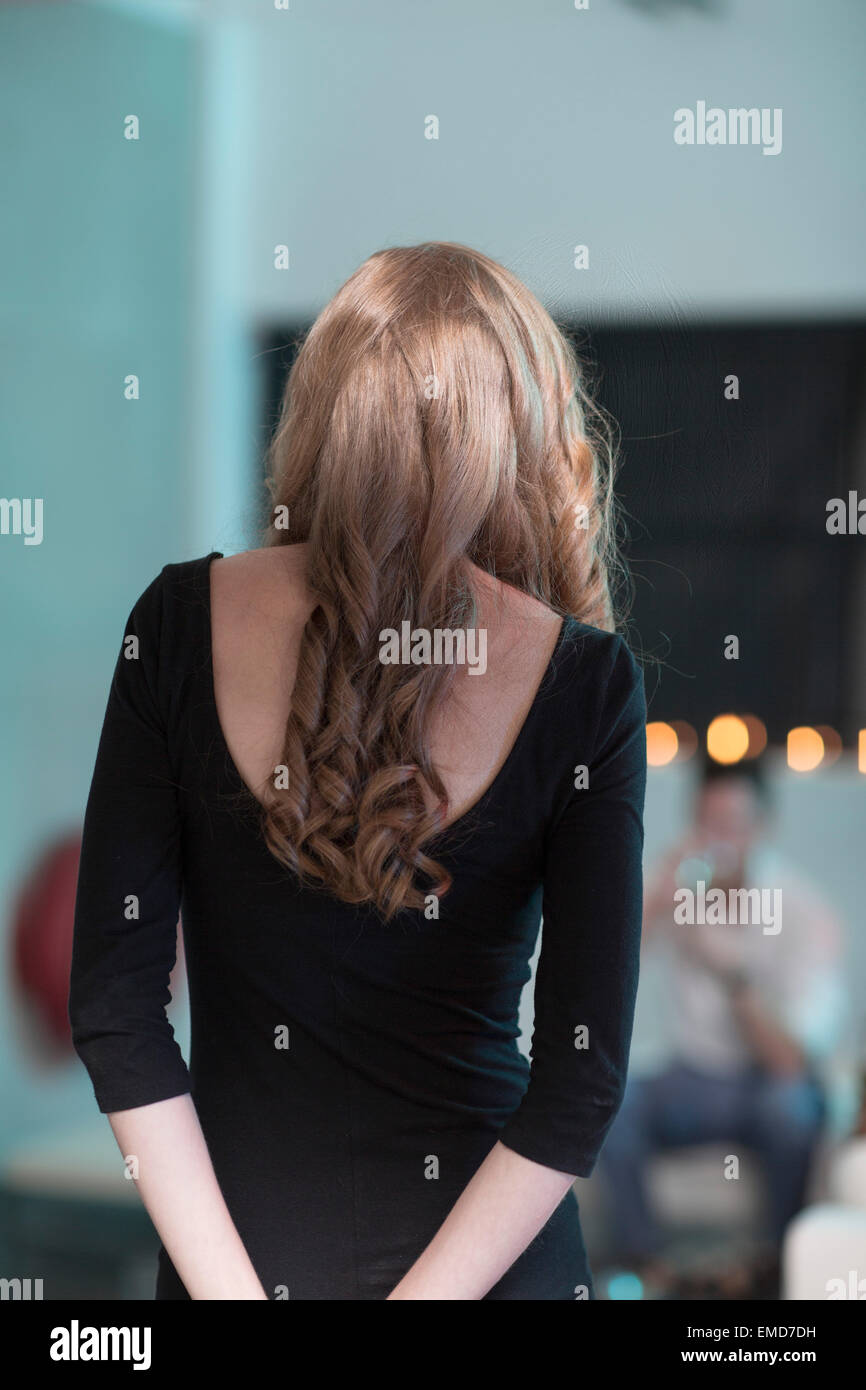 Back view of young woman wearing black dress Stock Photo - Alamy