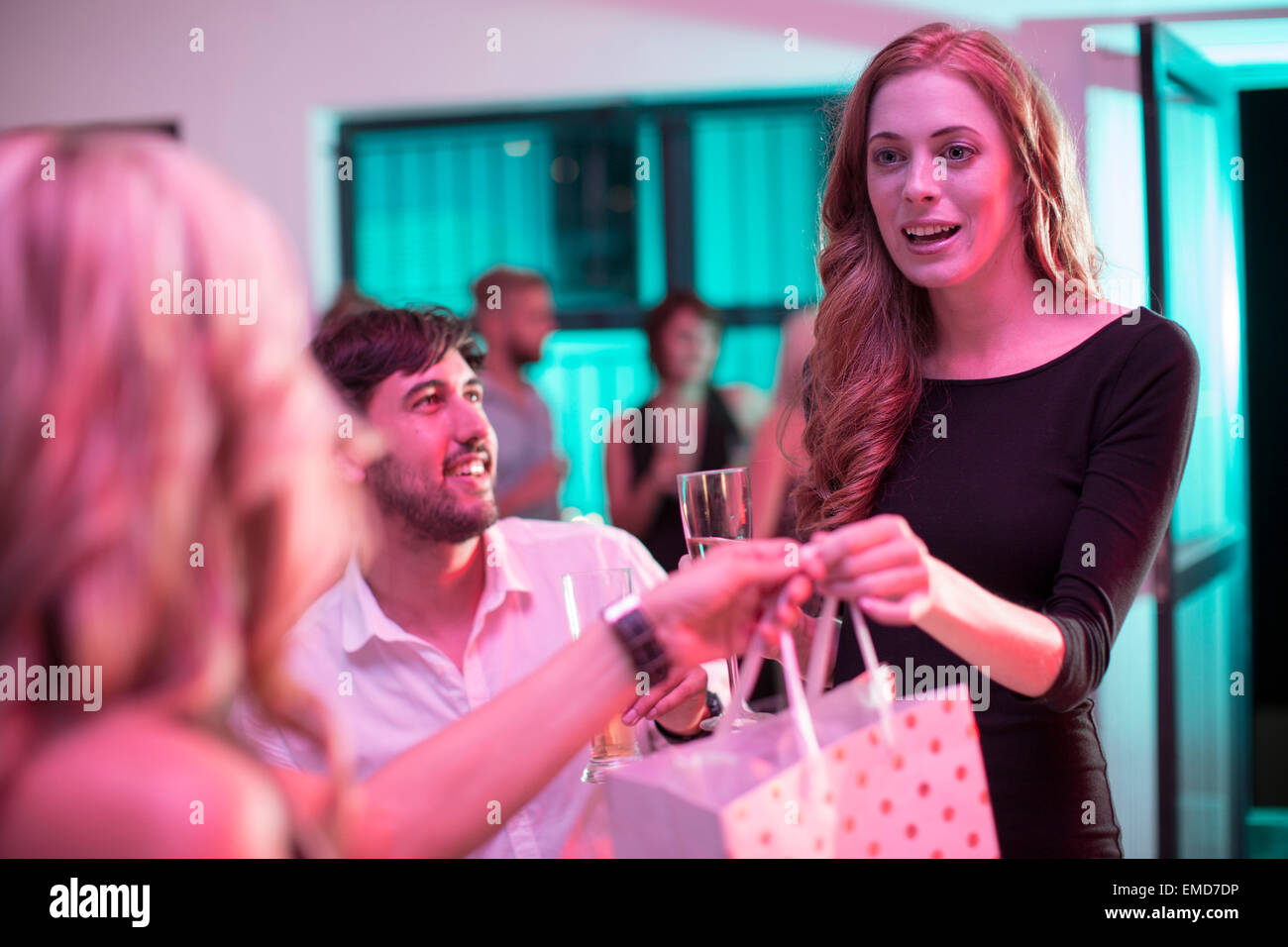 Portrait of young woman receiving a gift at party Stock Photo - Alamy