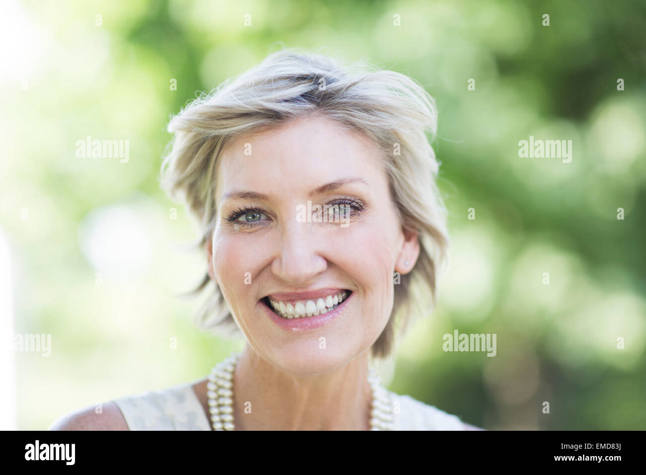 Portrait of smiling mature woman outdoors Stock Photo - Alamy