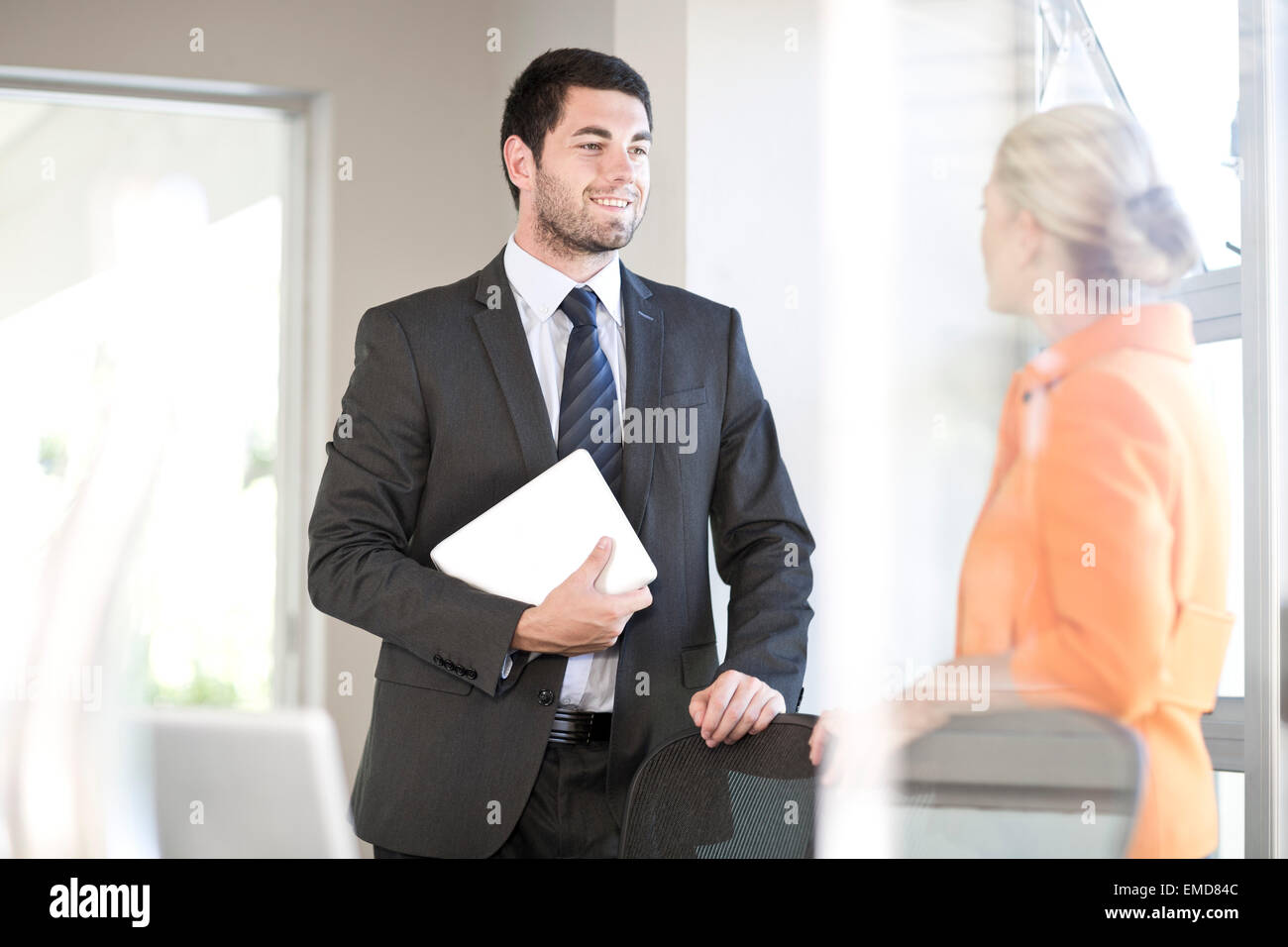 Two communicating business people in an office Stock Photo - Alamy