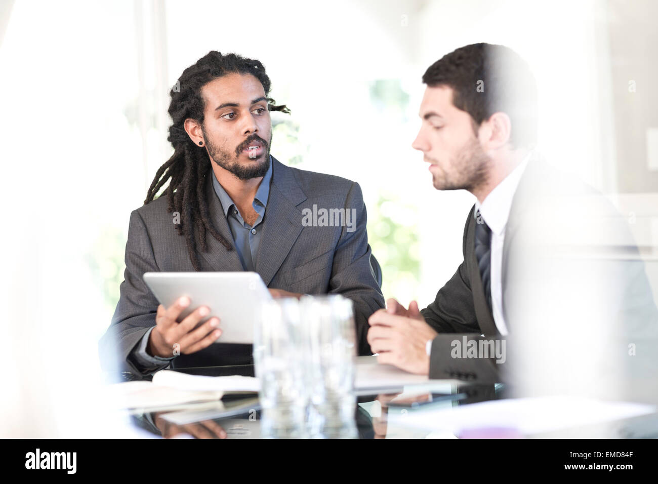 Two communicating businessmen in an office Stock Photo - Alamy