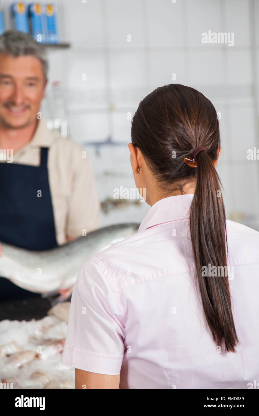 Woman buying fish Stock Photo - Alamy