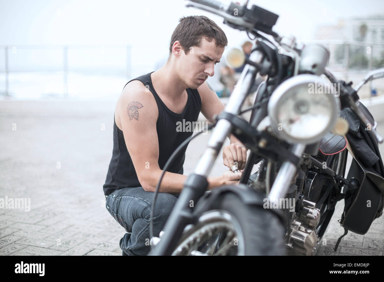 Biker checking motorcycle Stock Photo - Alamy
