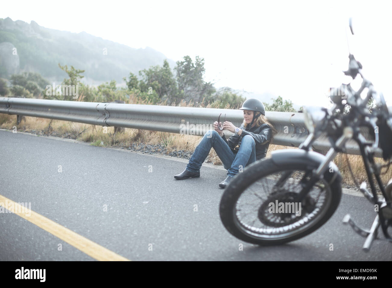 Woman stranded with broken motorcycle on the road Stock Photo - Alamy