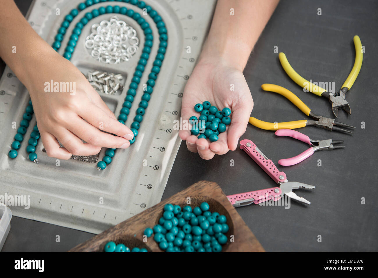 Close-up of woman working with beads to create a necklace Stock Photo ...