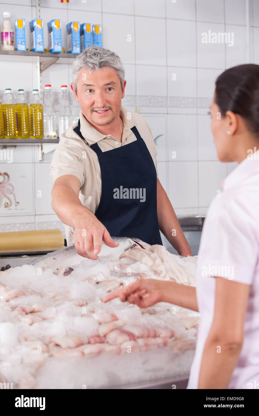 Old woman buying fish hi-res stock photography and images - Alamy
