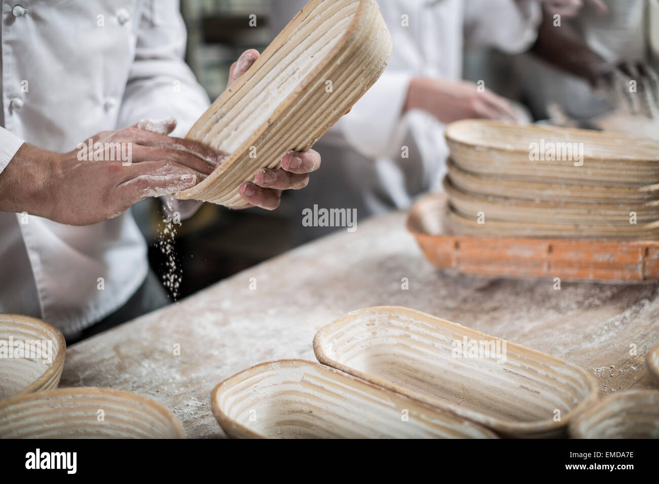 Baker preparing ceramic bowls for baking bread Stock Photo - Alamy