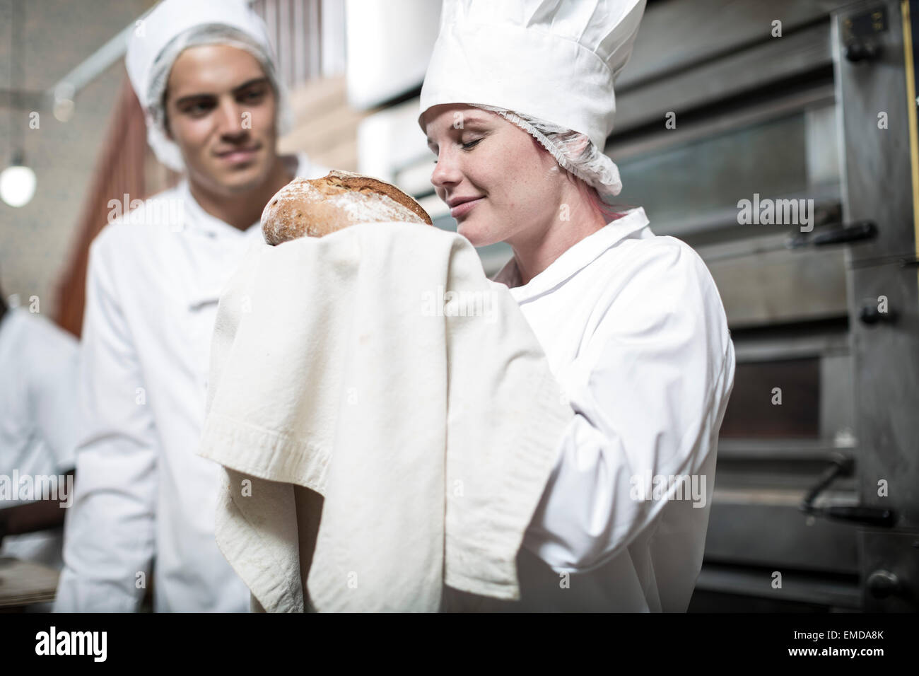 Female baker excited over baked bread fresh from the oven Stock Photo ...