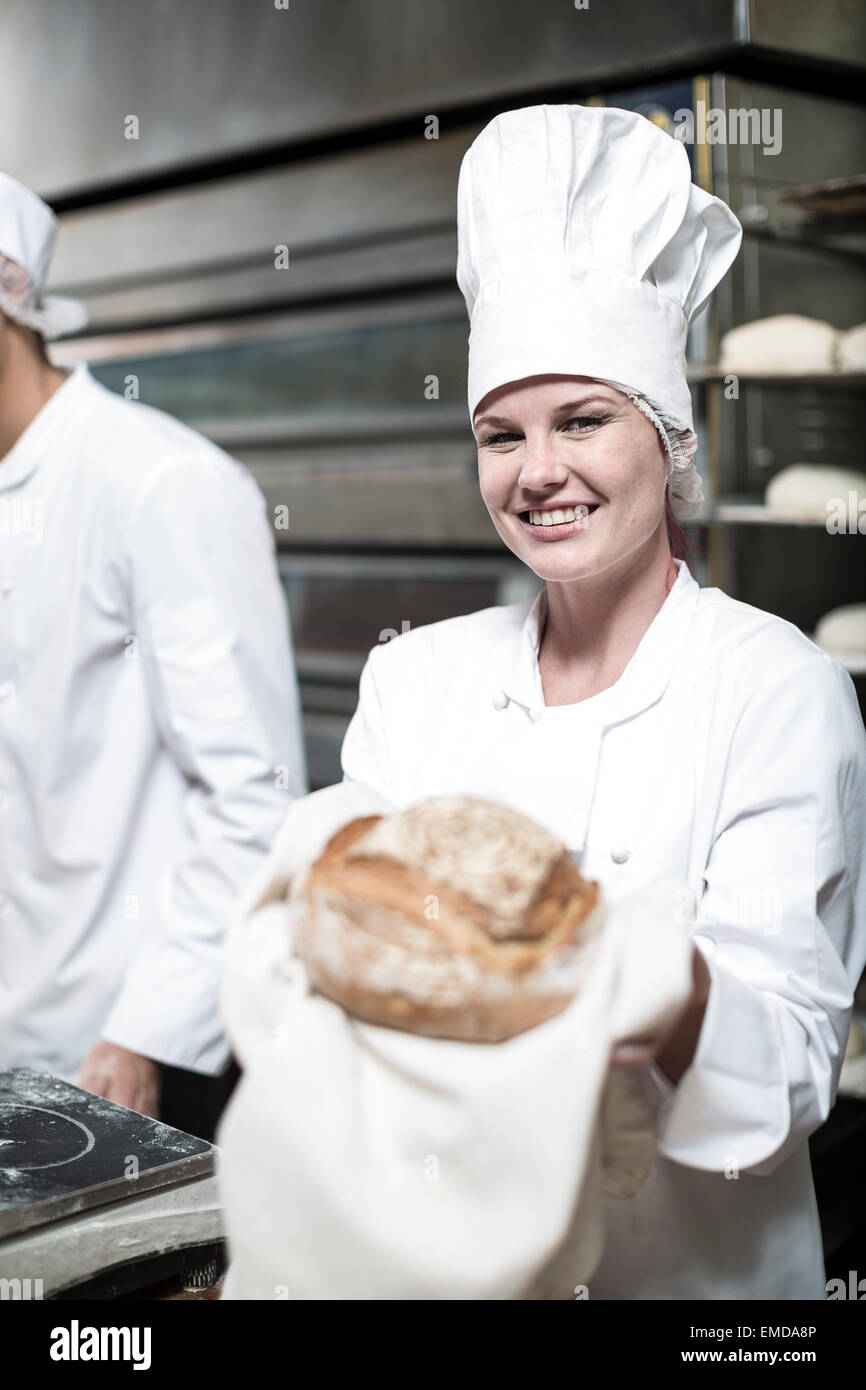 Female baker excited over baked bread fresh from the oven Stock Photo ...