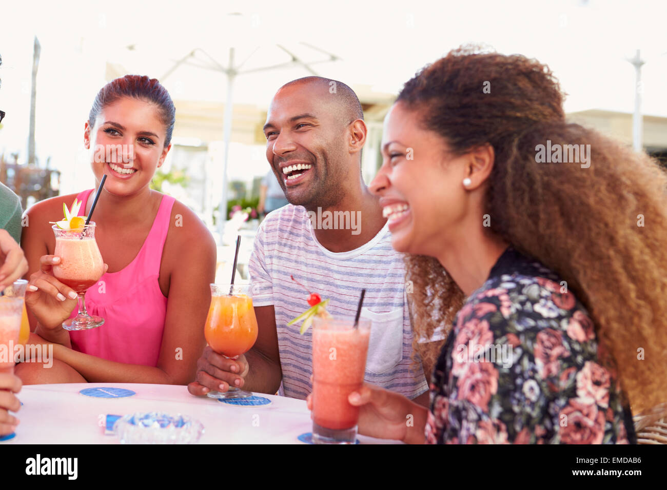 Group Of Friends Drinking Cocktails At Outdoor Bar Stock Photo - Alamy