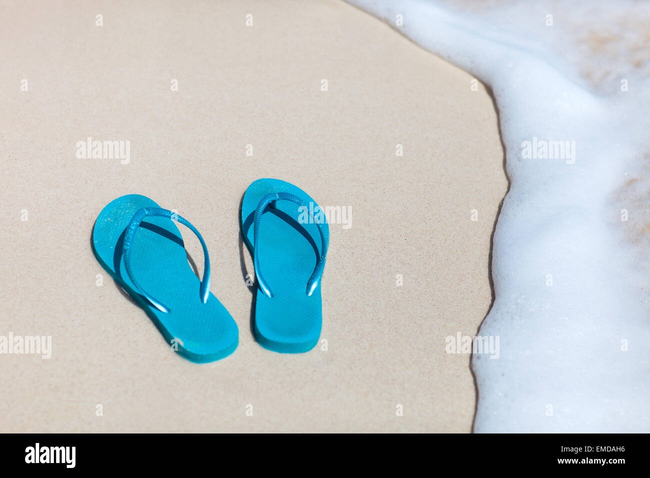 Flip flops on a tropical beach Stock Photo - Alamy