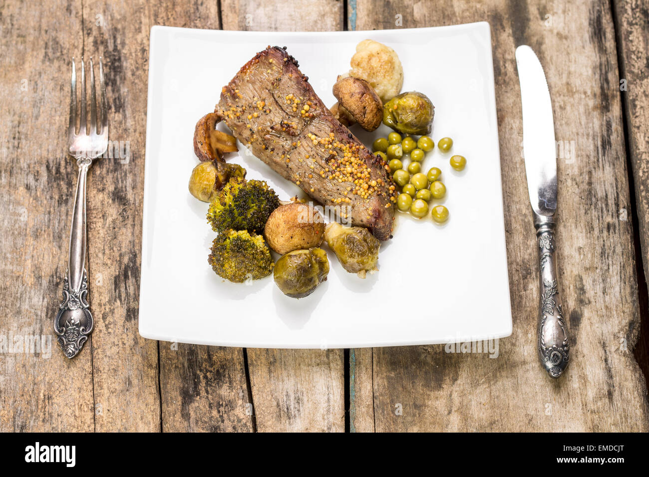 Restaurant menu background. Roasted chop of beef with vegetables on ...
