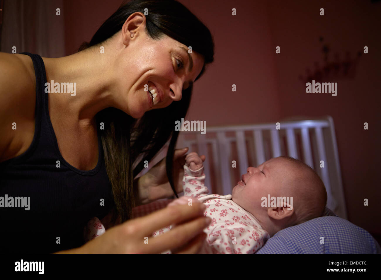 Mother Comforting Crying Baby In Nursery Stock Photo - Alamy