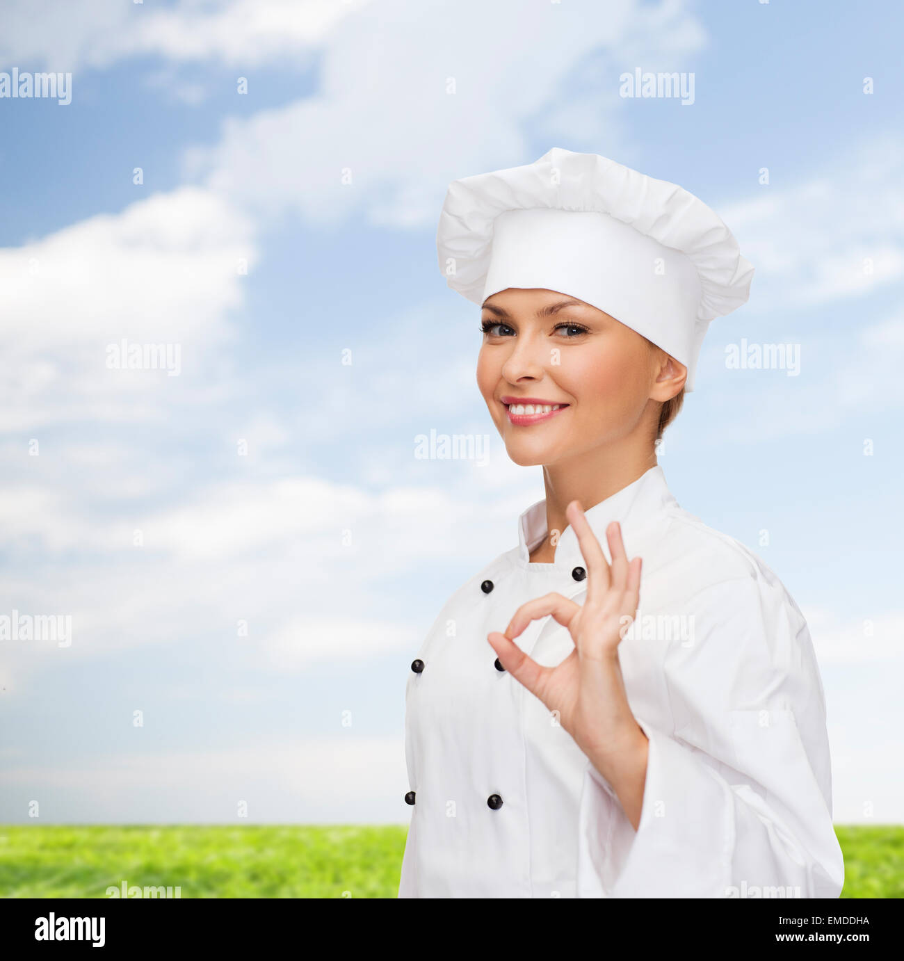 smiling female chef showing ok hand sign Stock Photo - Alamy
