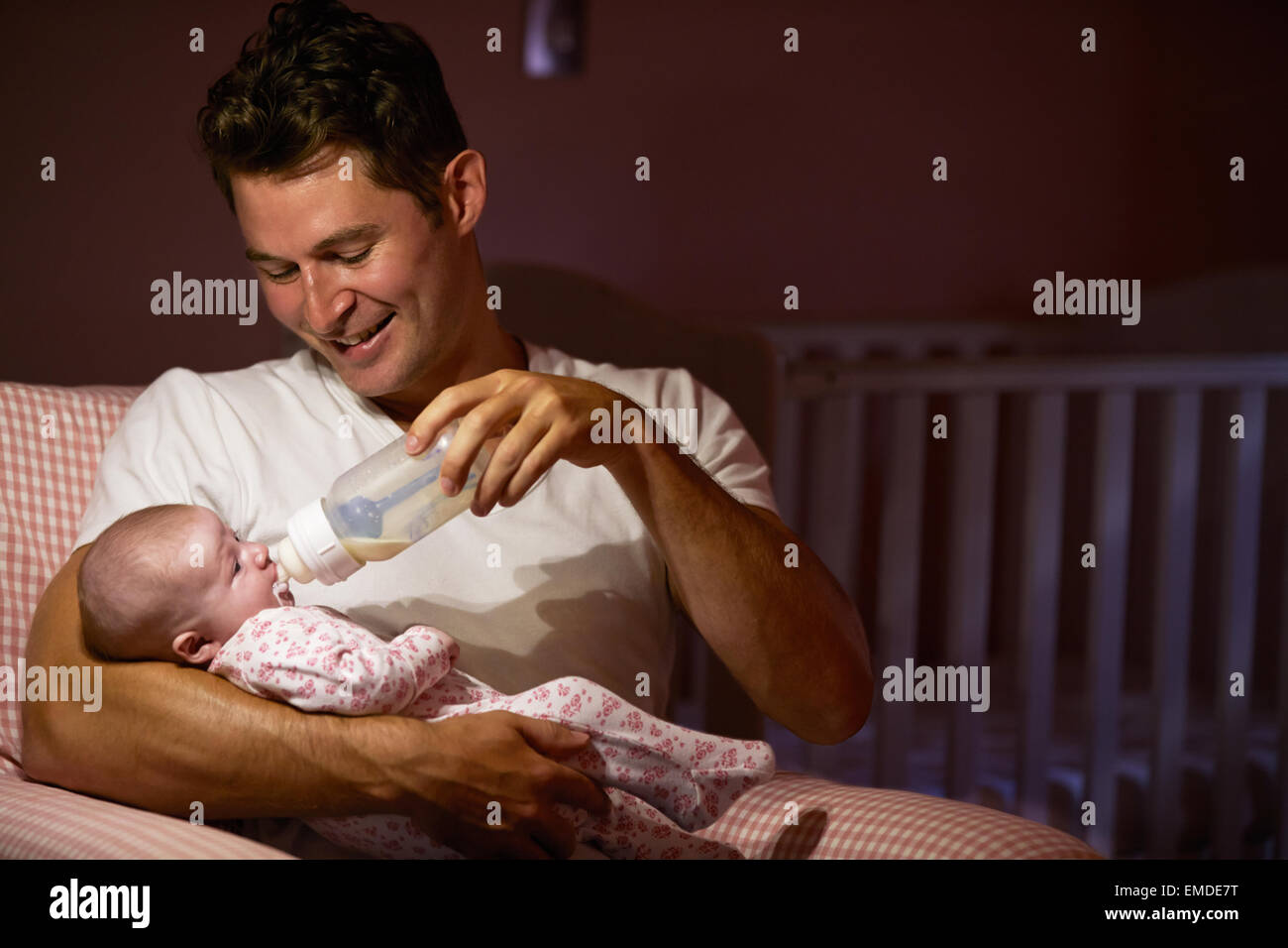 Father feeding baby daughter in chair hi-res stock photography and ...