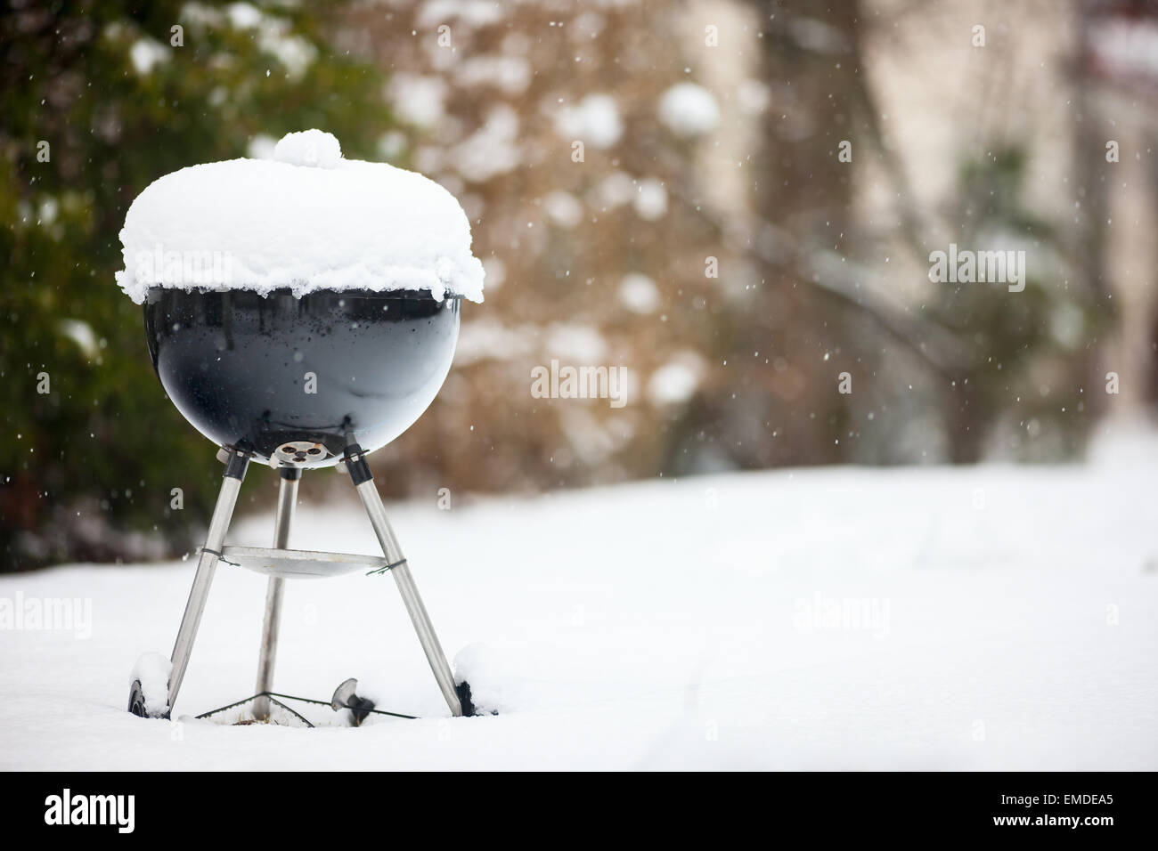 Barbeque grill covered with snow Stock Photo - Alamy
