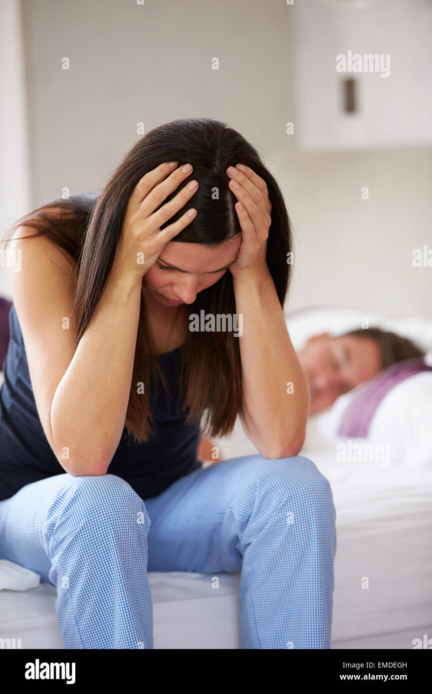Woman Suffering From Depression Sitting On Bed Stock Photo - Alamy