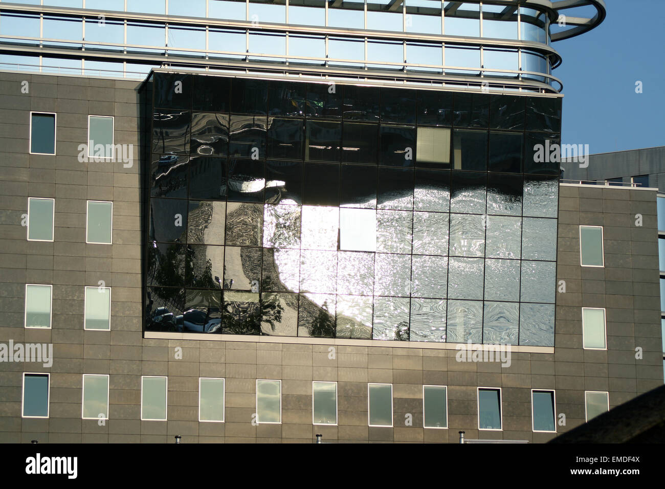 Building with water reflecting Stock Photo - Alamy