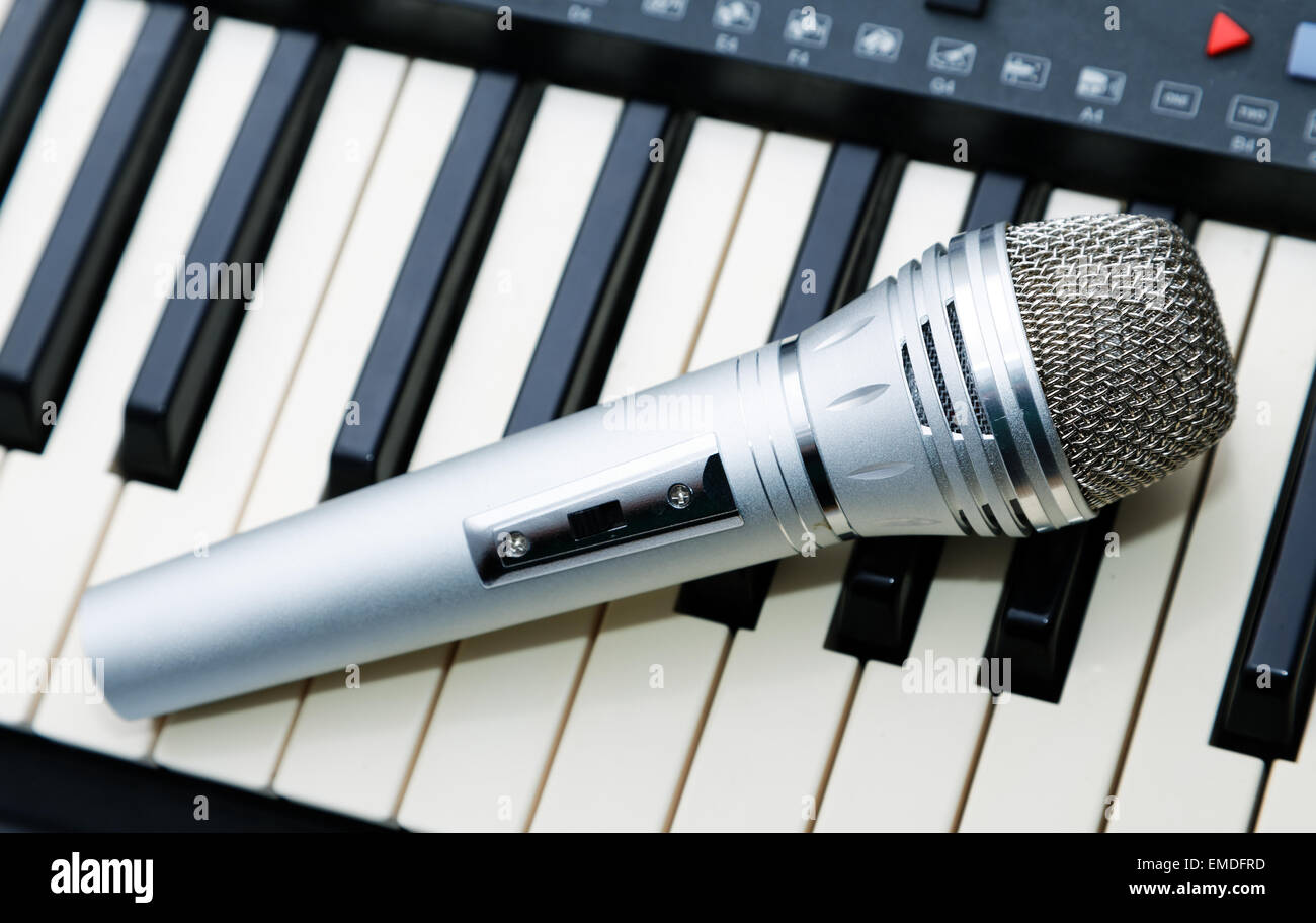 The microphone lies on the synthesizer keyboard Stock Photo - Alamy